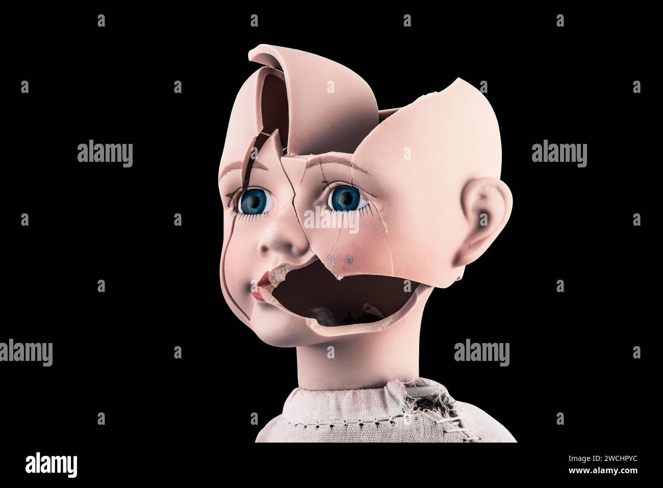 Broken vintage doll head isolated on black background with clipping ...