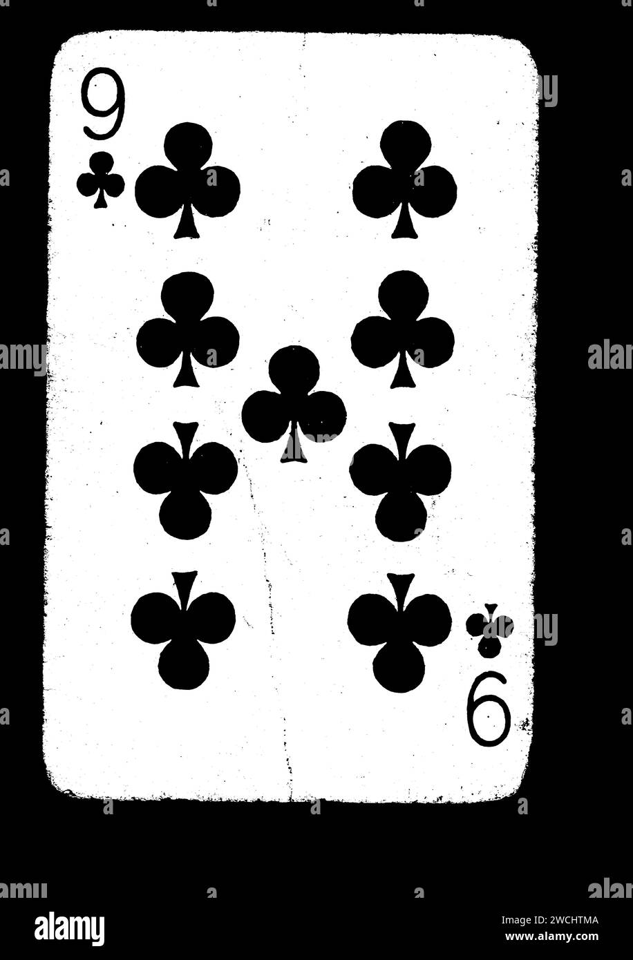 A vintage nine of clubs playing card isolated on a black background ...