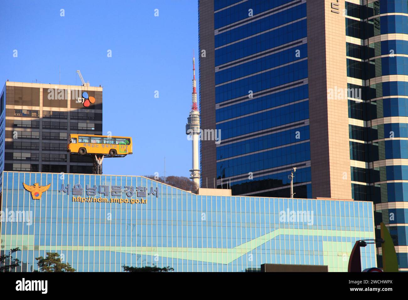 Statue of Policeman carrying Yellow School bus on top of the Police ...
