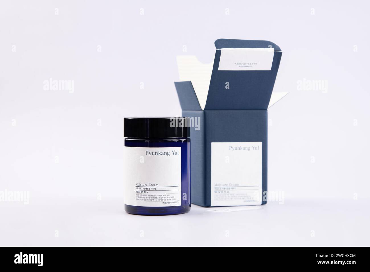 glass bottle of Pyunkang Yul brand face moisturizer next to the box. On ...