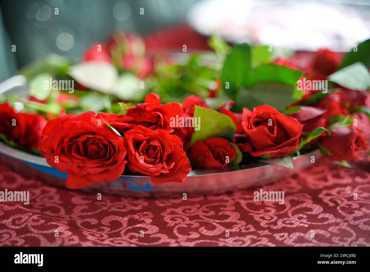 Red rose flowers placed in the steel plate with designed cloth ...