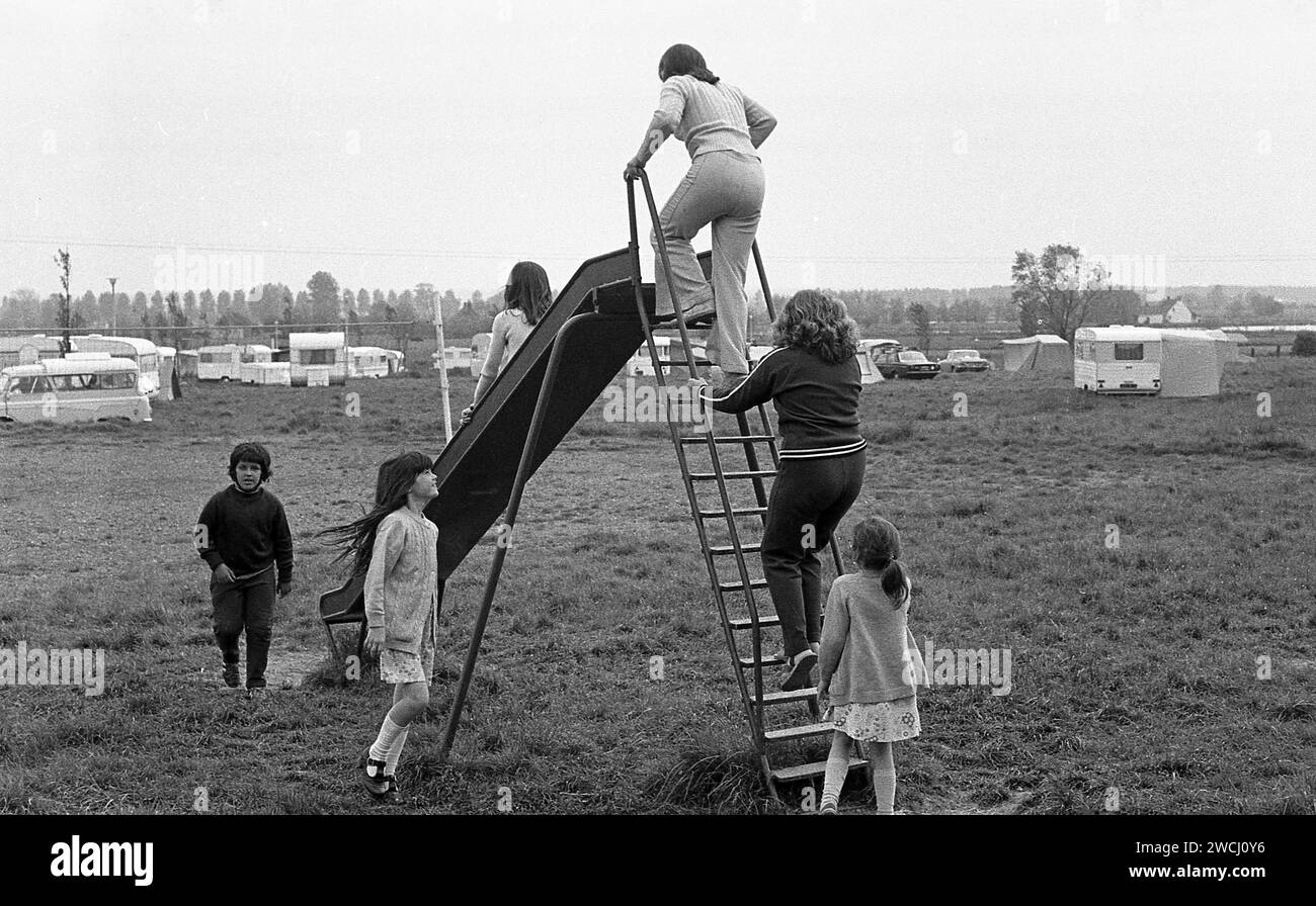 1960s, historical, outside in a grassy field at a camping/caravan site ...