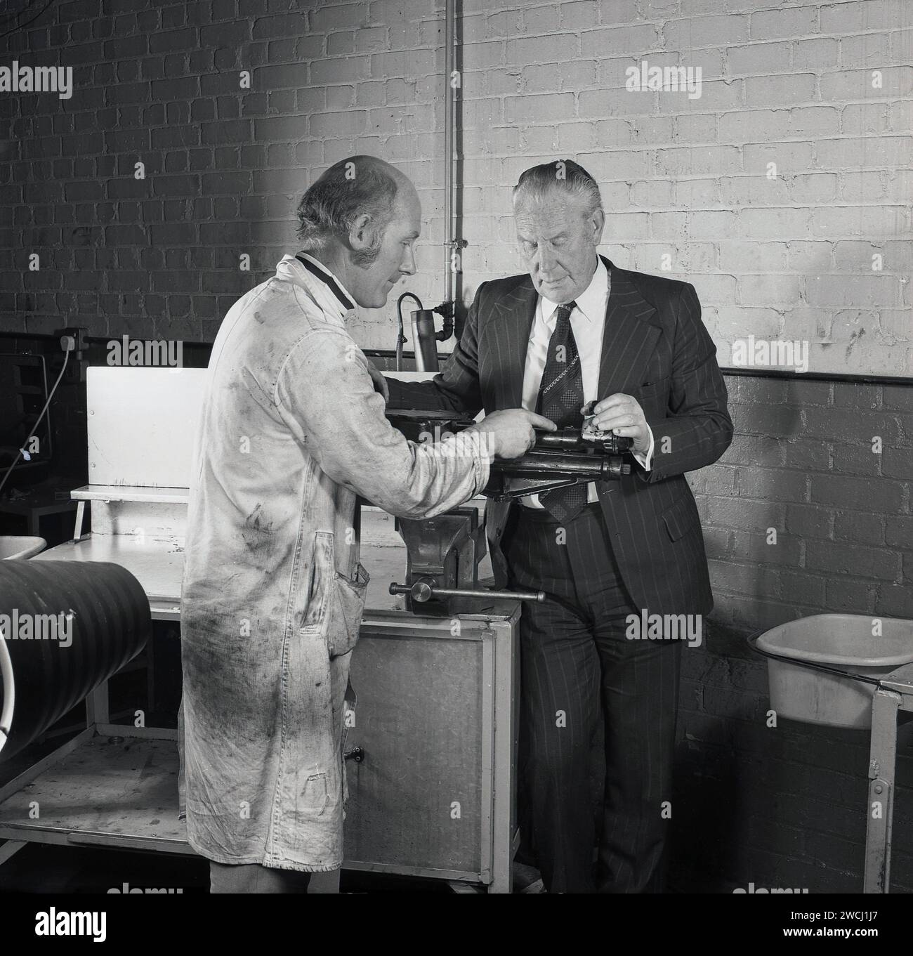 1970s, historical, in the workshp of an automotive dealer, a mechanic ...