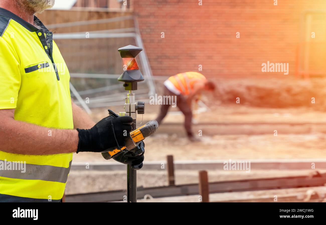 Site engineer surveyor using rugged tablet controller computer to ...