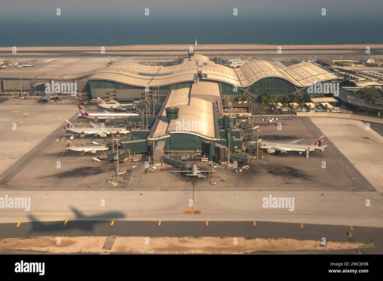 A commercial airplane takes off from Hamad International Airport in ...
