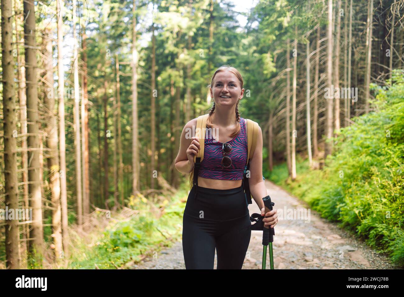 Adventure. Pretty young female backpacker woman enjoying green ...
