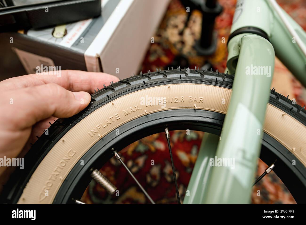 A detailed view of a persons hand on a bicycle tire, highlighting the ...