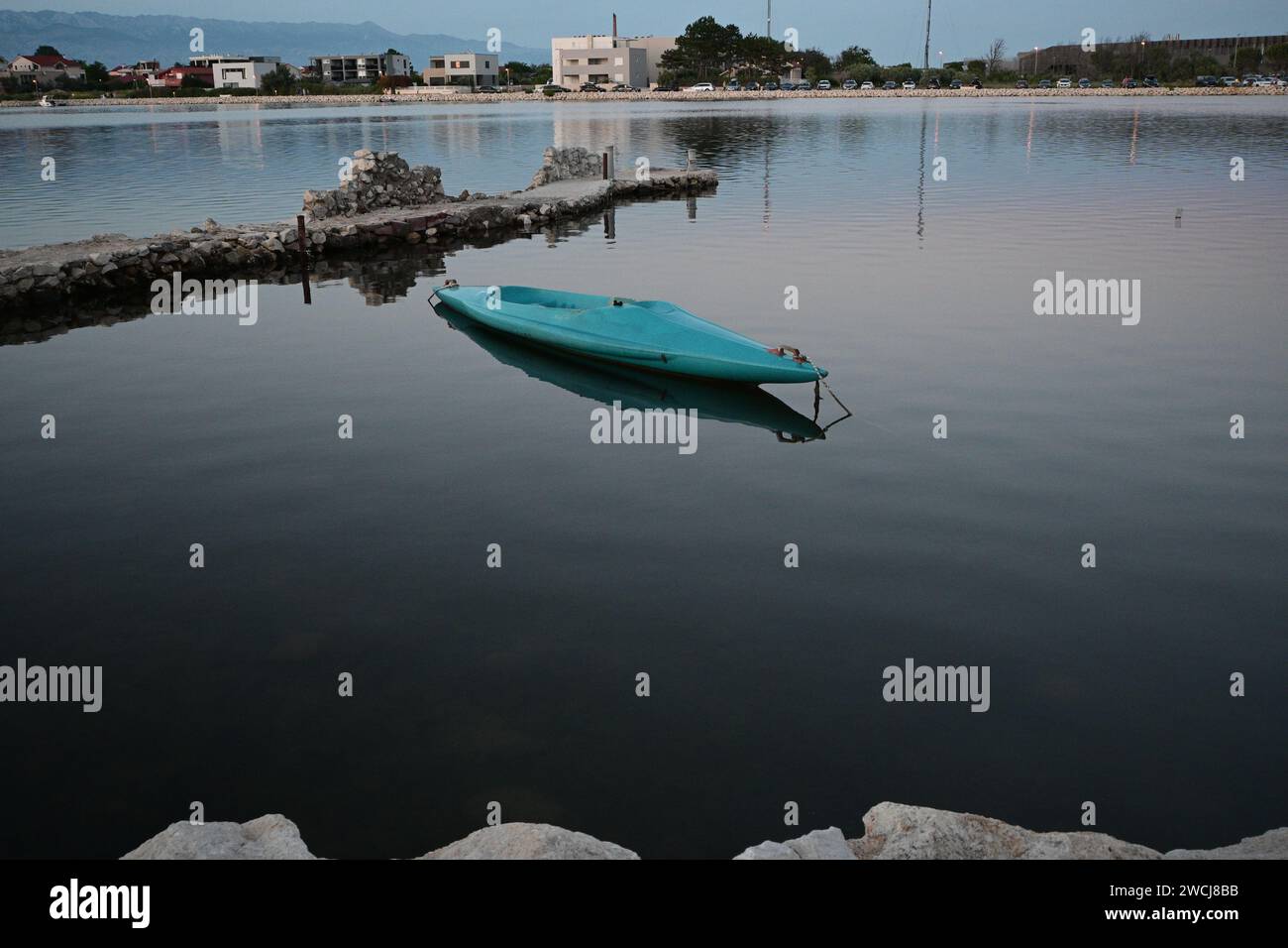 old blue dilapidated kayak at sea Stock Photo - Alamy