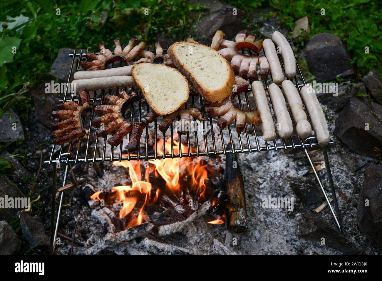grilled meat and sausages on the grill. baked on an open fire Stock ...