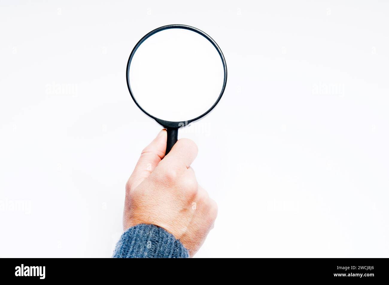 hand with magnifier, search information concept Stock Photo - Alamy