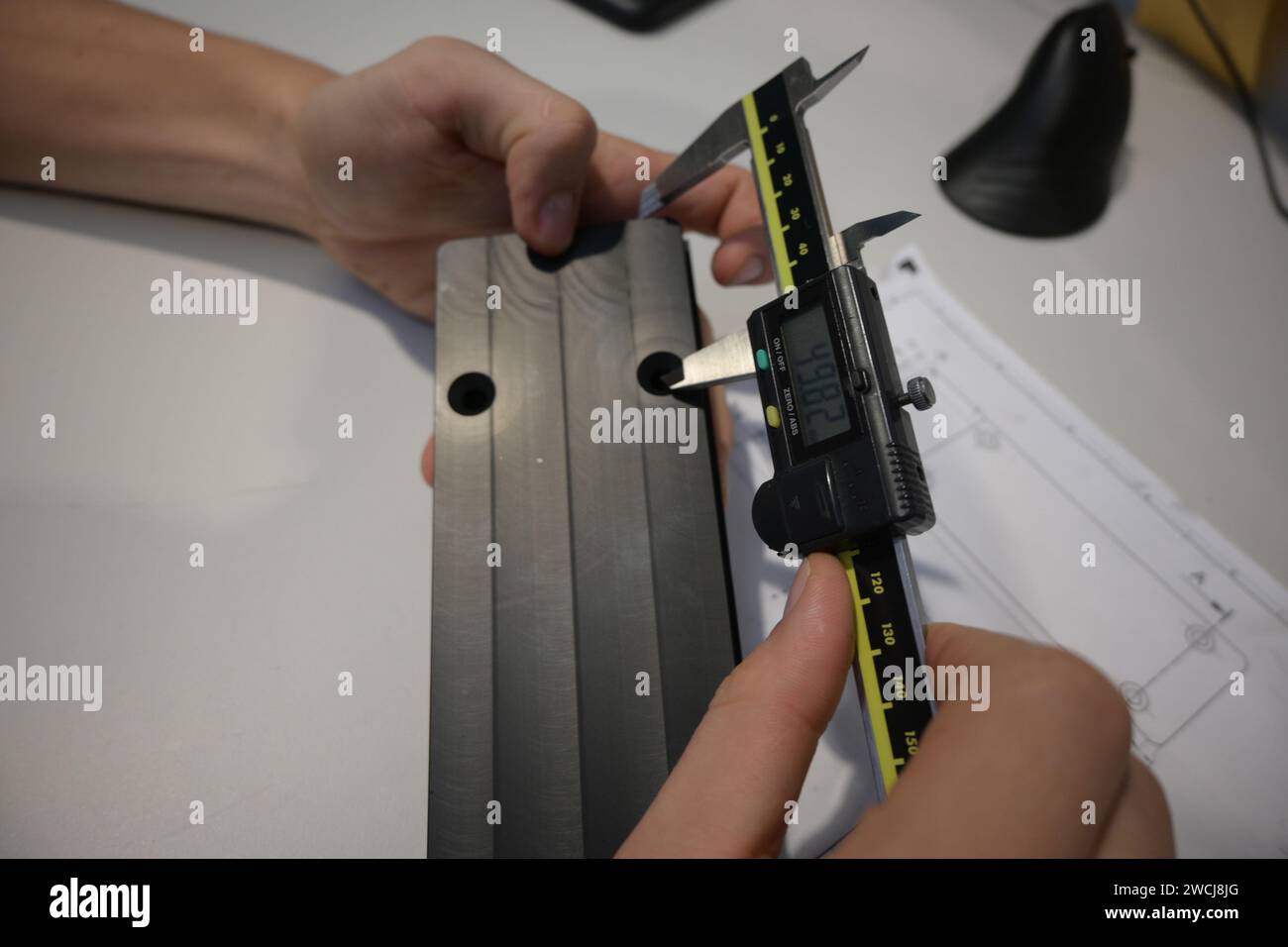 measuring the finished plastic product using a caliper Stock Photo - Alamy