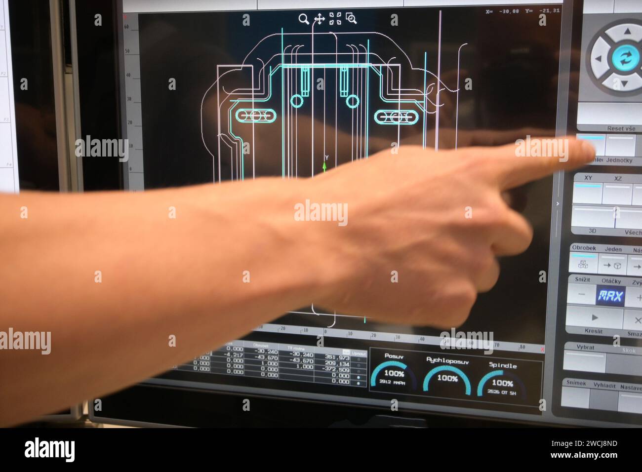 cnc monitor when displaying the program, the worker points with his ...