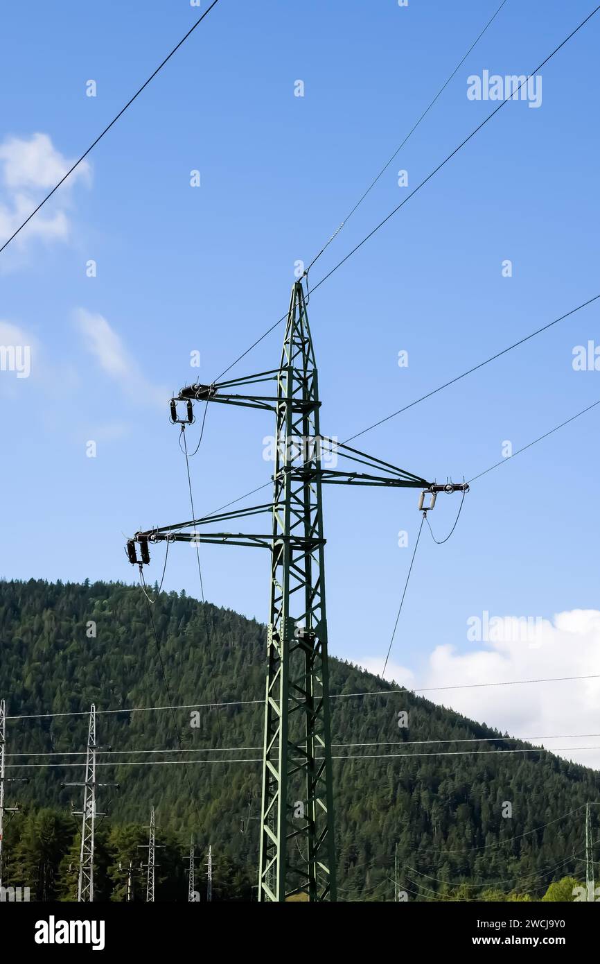Large power poles with power lines with forest background Stock Photo ...
