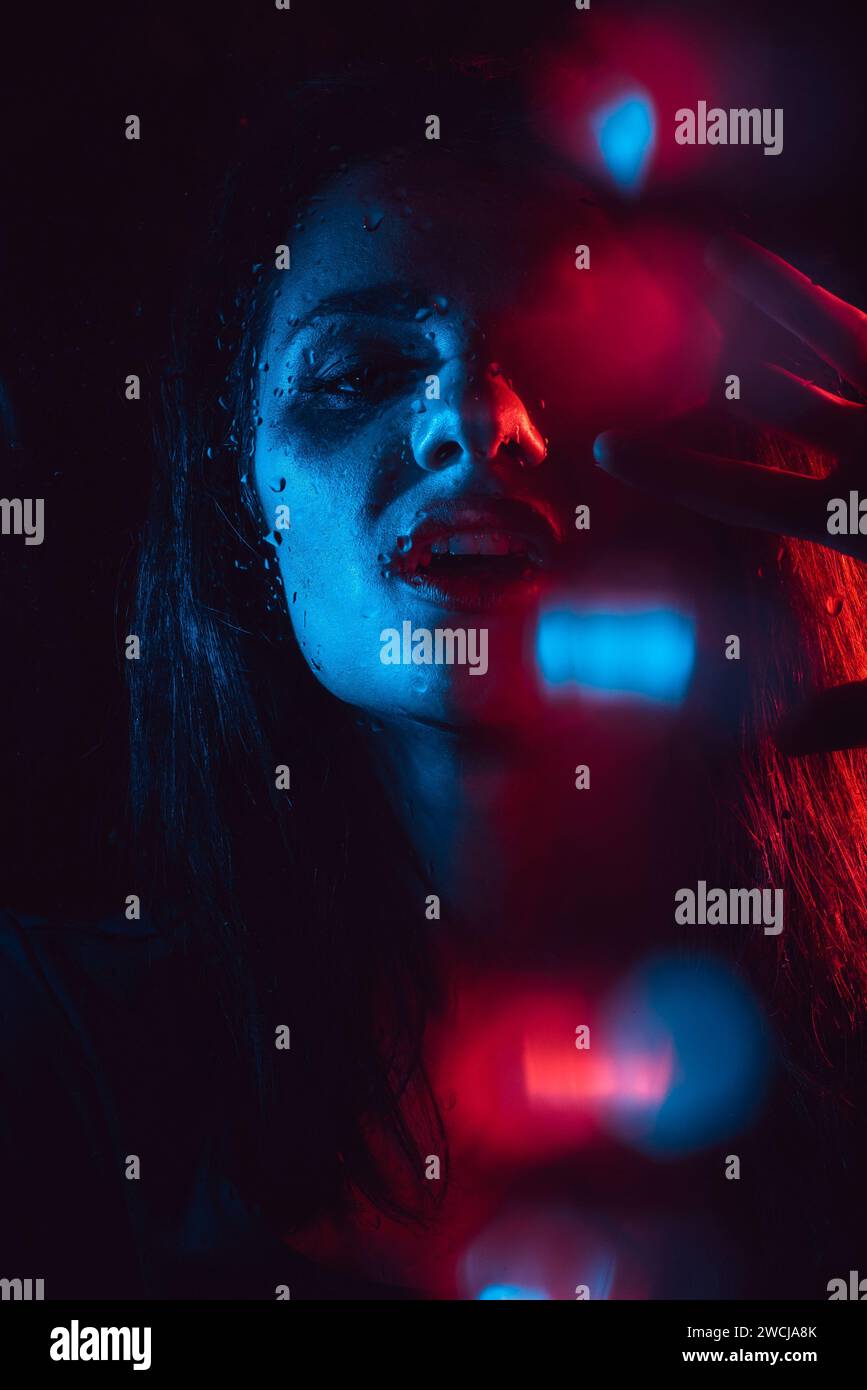 Sensual portrait of sad melancholic lonely girl behind glass with ...