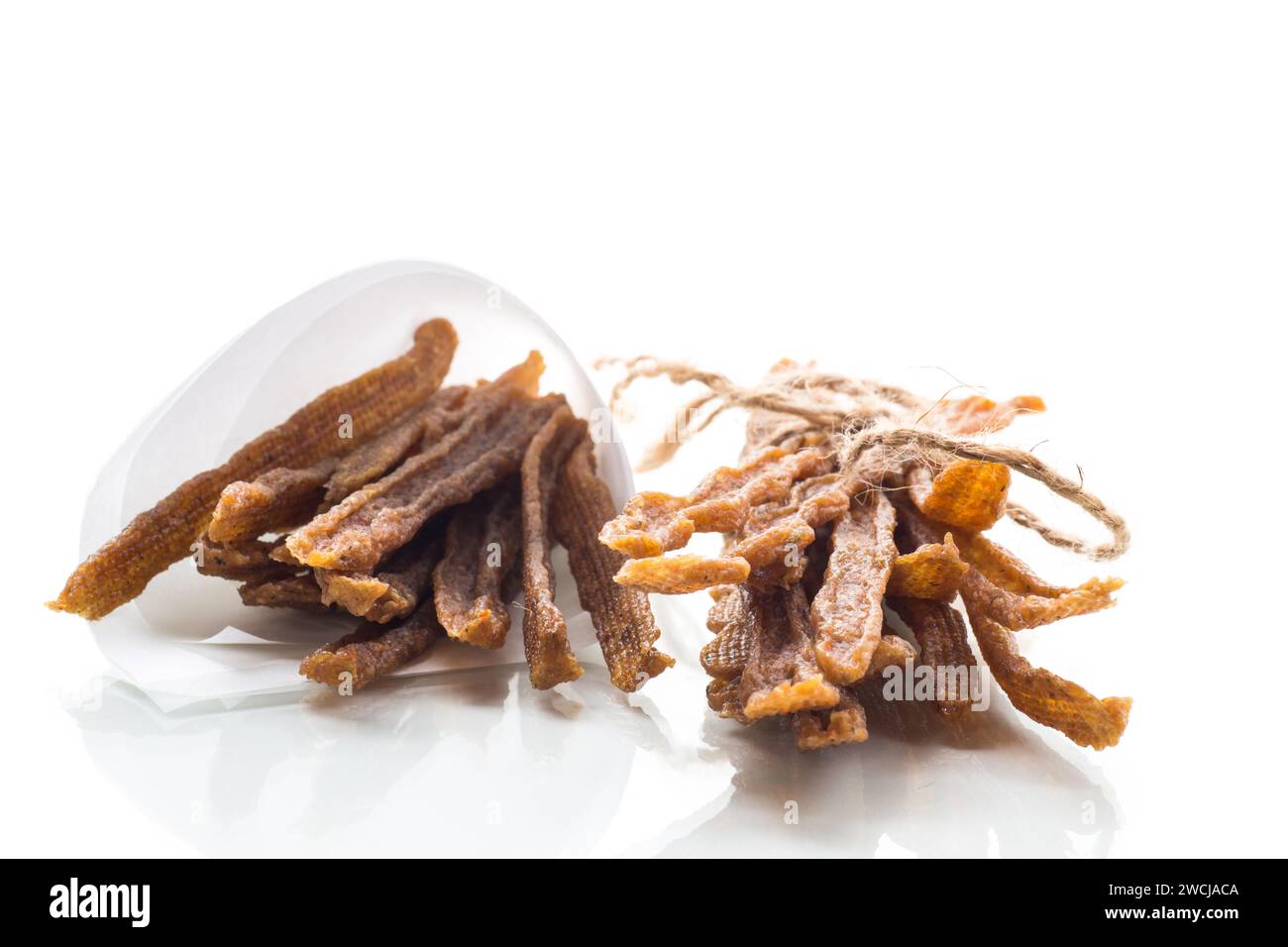 A handful of dried chicken meat, marinated with spices, isolated on a ...