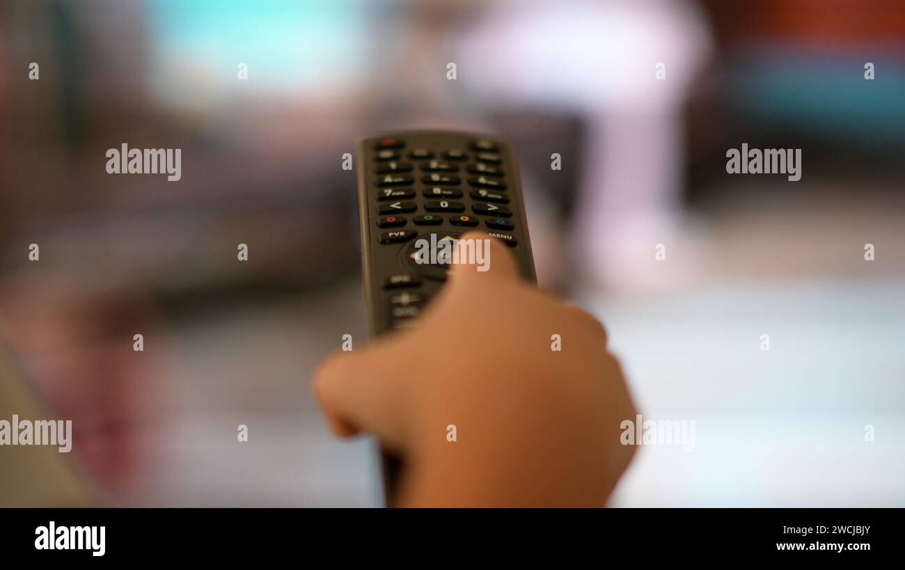 the child holds the remote control in his hand, a close-up view with a ...