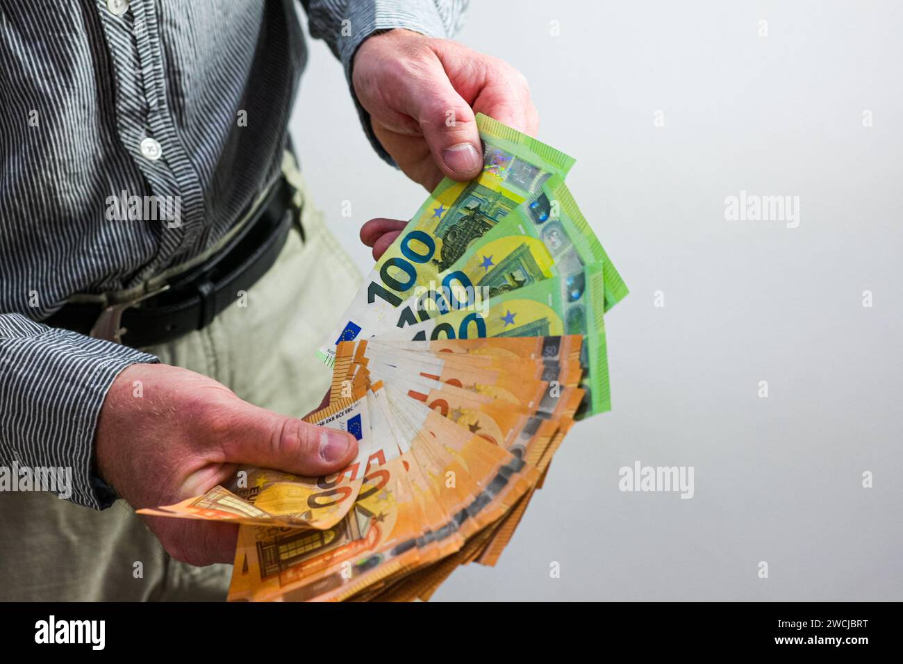 A series of banknotes arranged in the shape of a fan. Cash, 50 euro and ...