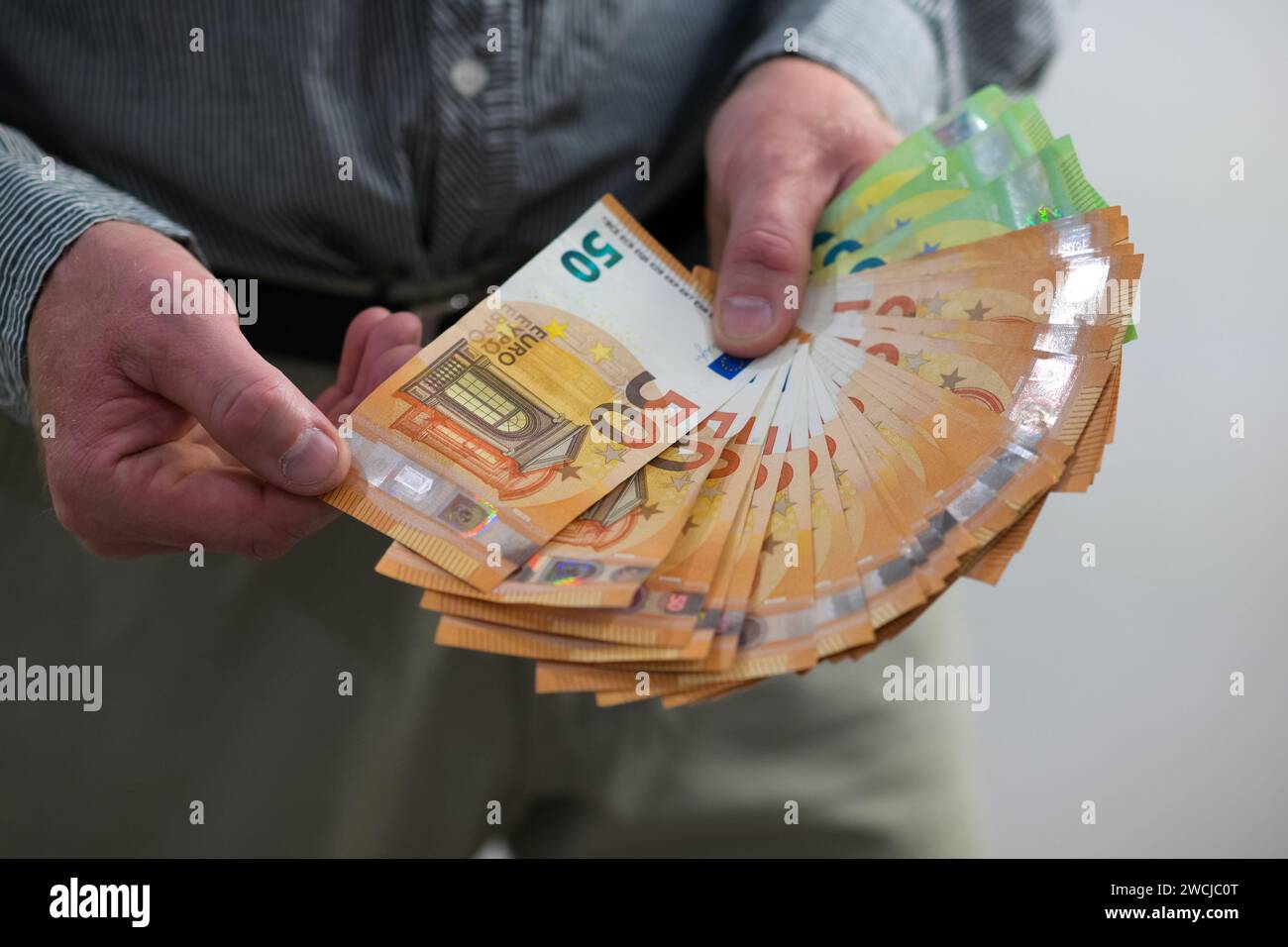 A series of banknotes arranged in the shape of a fan. Cash, 50 euro and ...