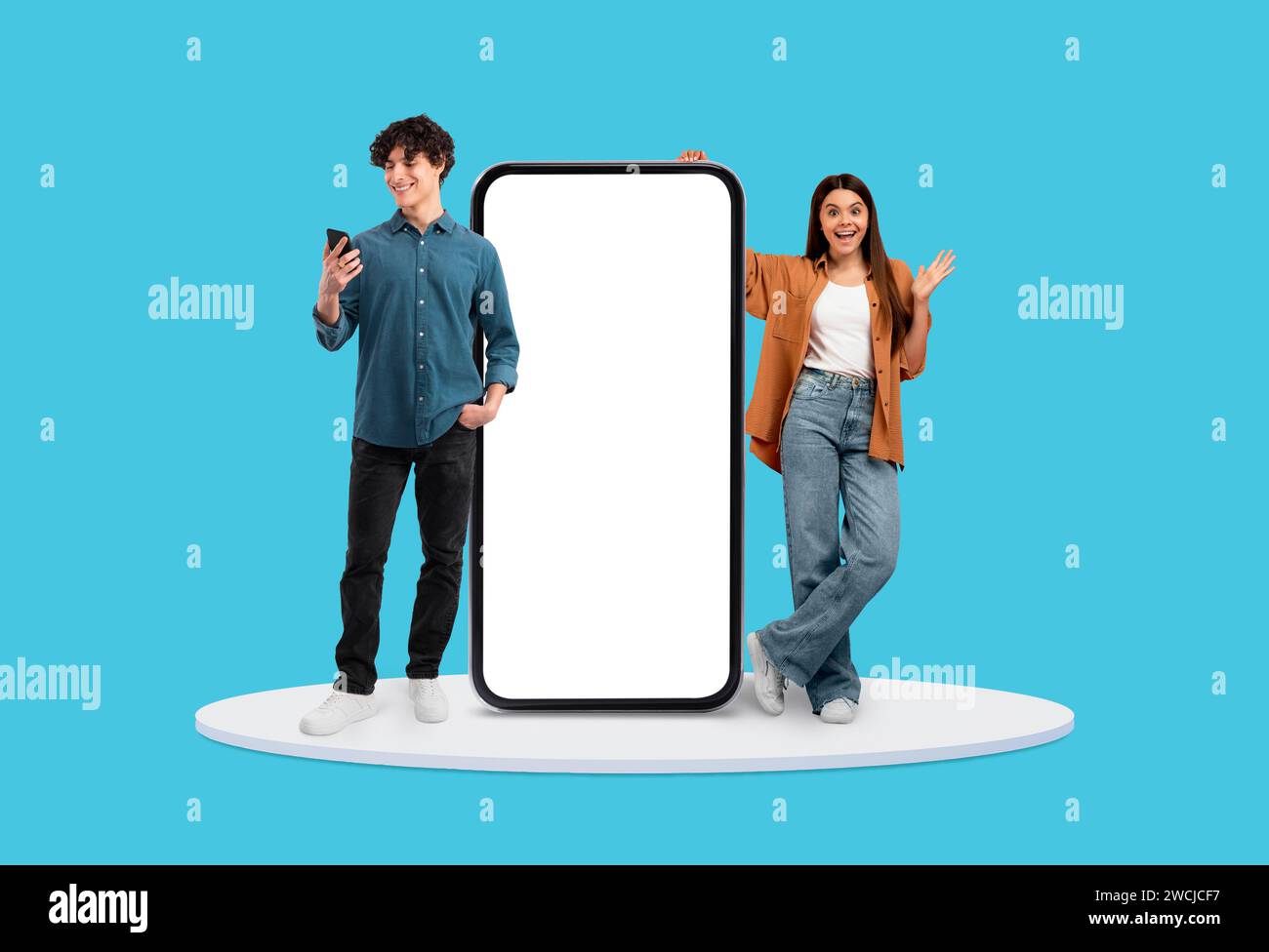 Joyful duo with giant phone screen, man holding real phone Stock Photo ...