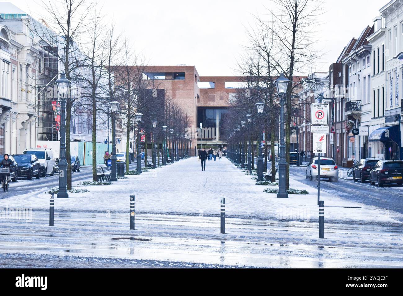 Breda, Netherlands. 14th Jan, 2024. People walk through the snow on the ...