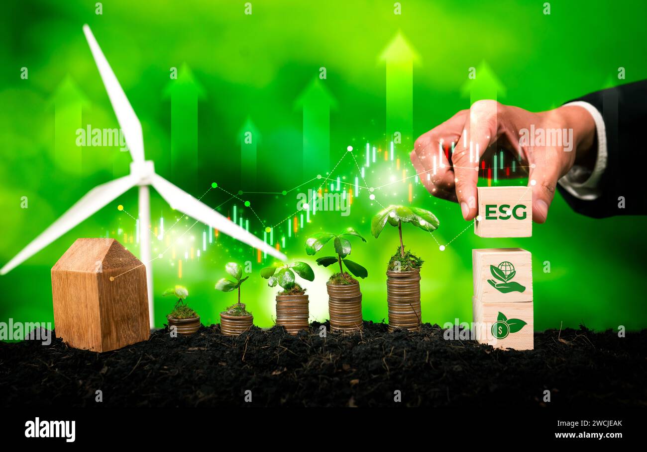 Growing coin or money stack with ESG businessman hand interacting ...