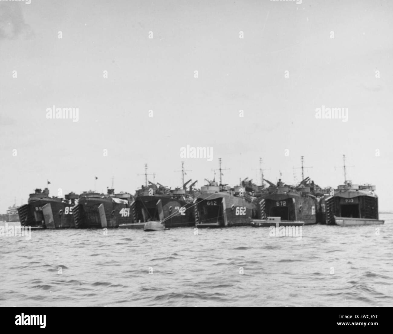 350133 Tank Landing Ships (LST) and a Barracks Ship (APB) moored ...