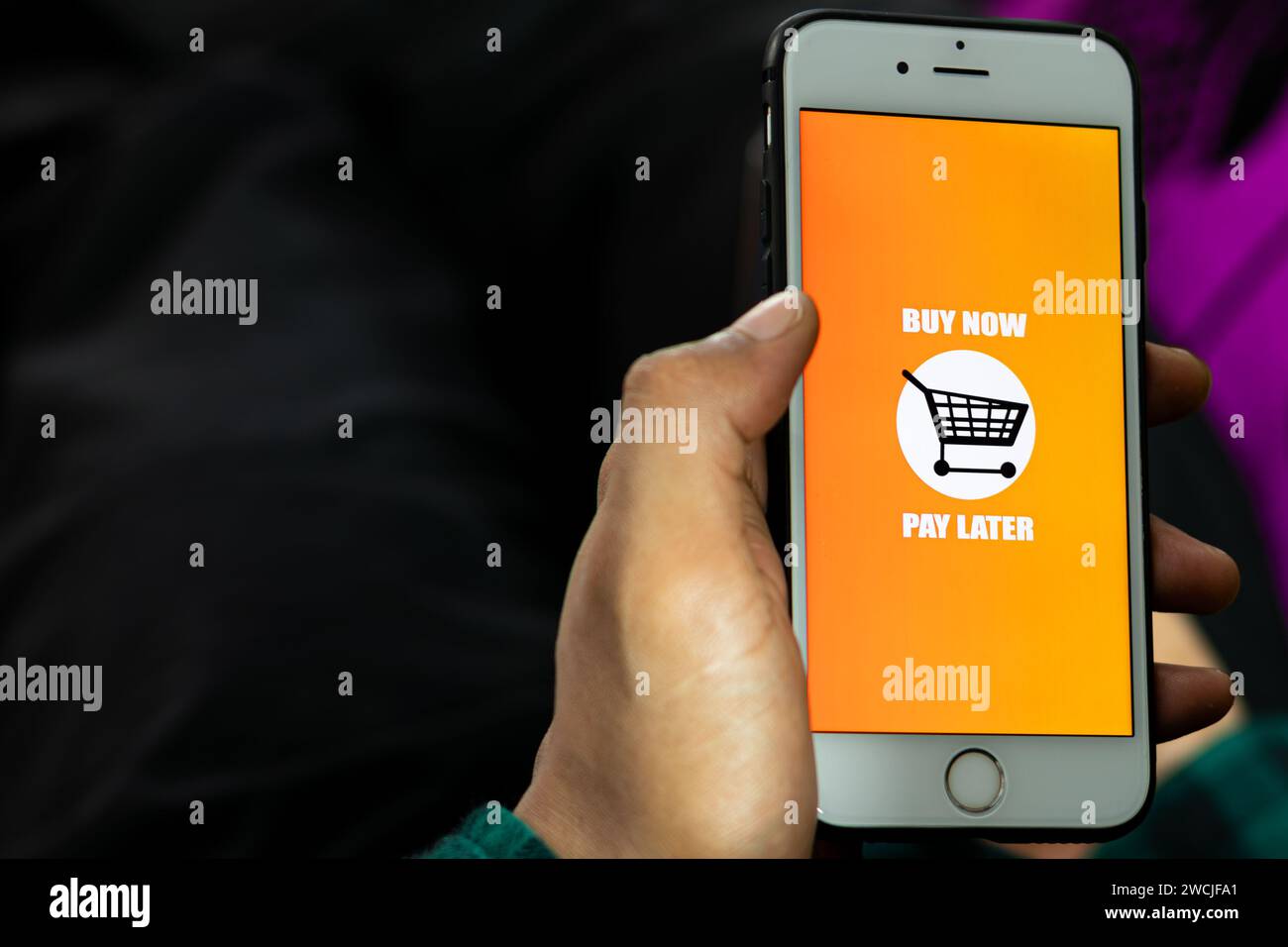 Online shopping concept. Man's hand holding a smartphone with BNPL Buy ...