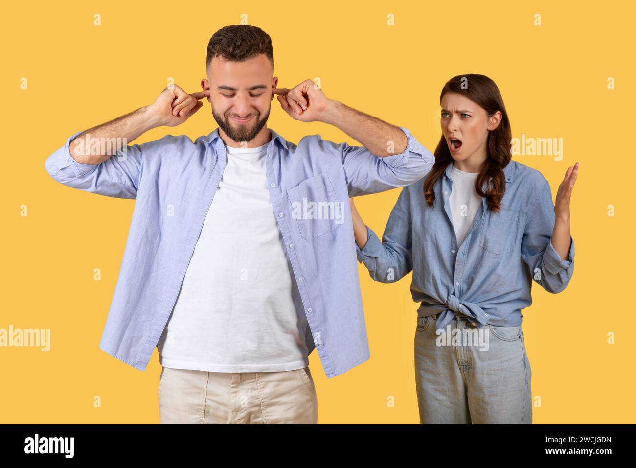 Man covering ears, woman arguing, communication breakdown on yellow ...