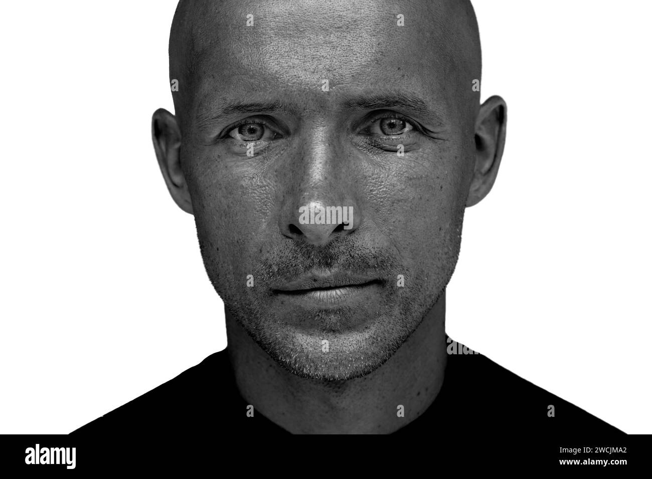 A high-contrast black and white portrait of a man on a white background ...