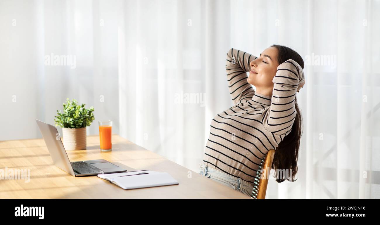 Woman leaning back desk hands hi-res stock photography and images - Alamy