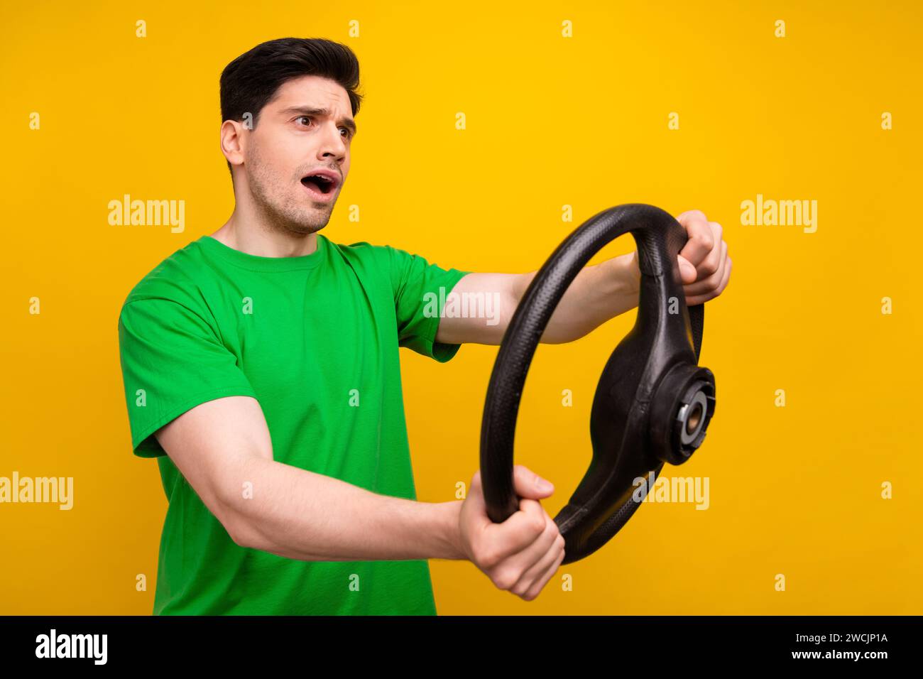 Photo portrait of handsome young brunet guy nervous hold steering wheel ...