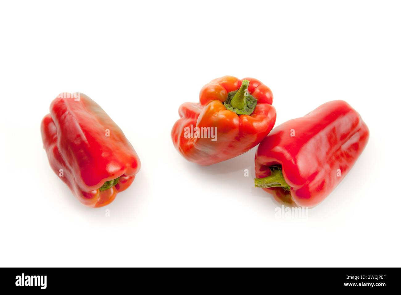 Three whole red bell pepper (capsicum) known as sweet bell pepper ...
