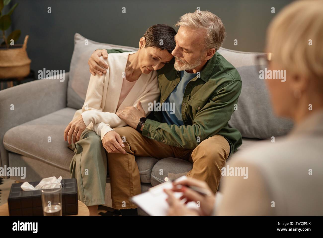 Portrait of mature adult couple embracing and supporting each other in ...