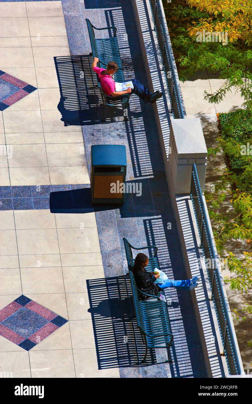 Aerial View of Two People Reading on Outdoor Benches Stock Photo - Alamy