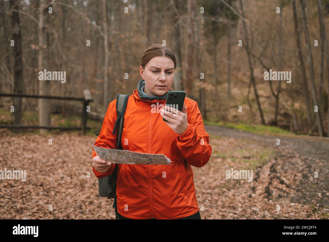 Traveler young woman searching direction with a map in the forest ...