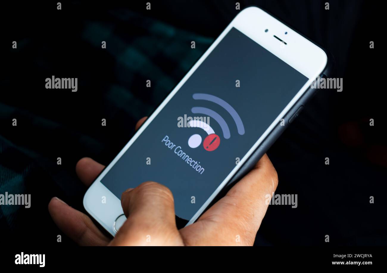 Close up of male hand holding a smart phone with sign bad connection on ...