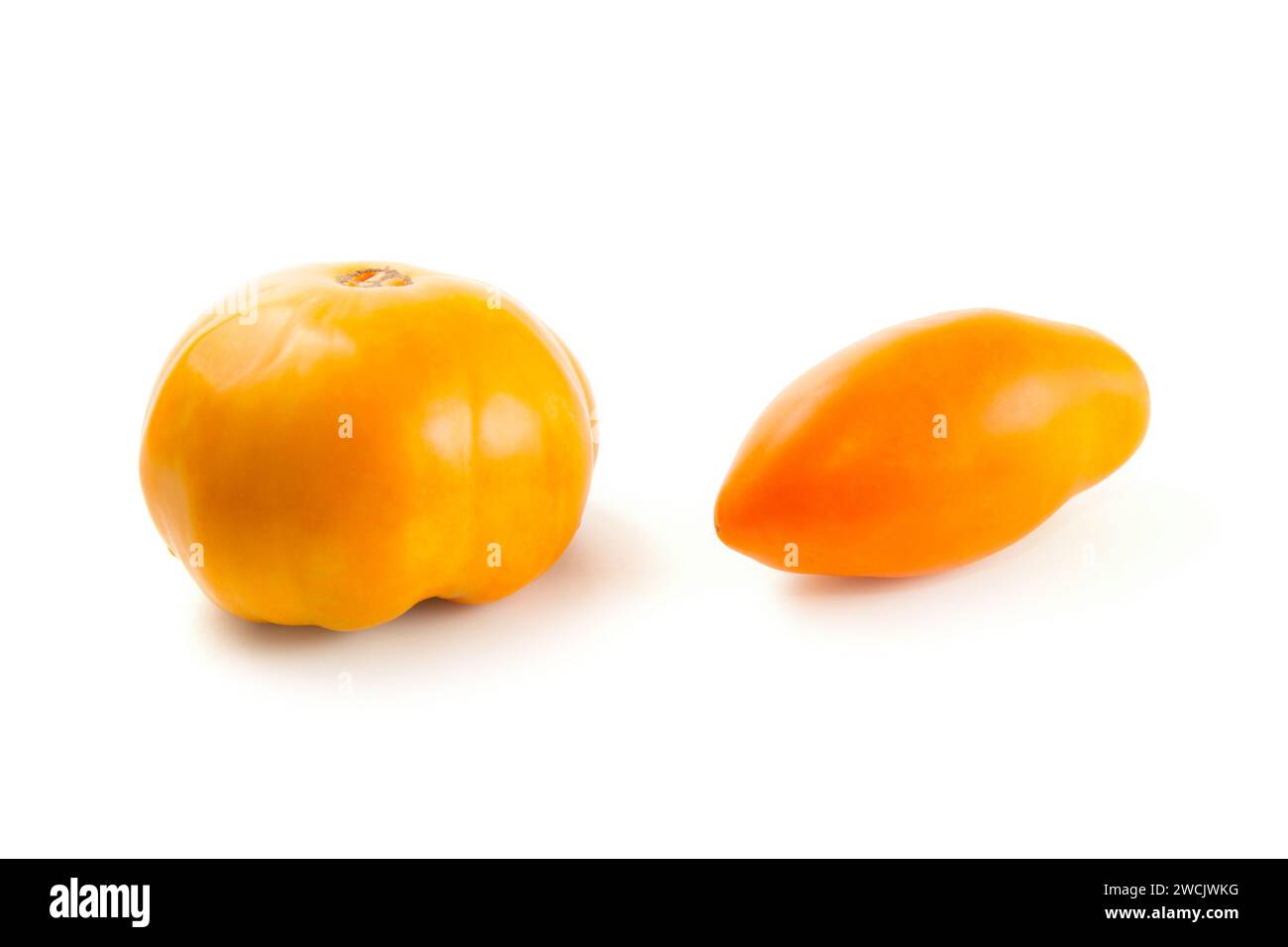 Assort of different shape of whole ripe juicy yellow tomatoes with soft ...