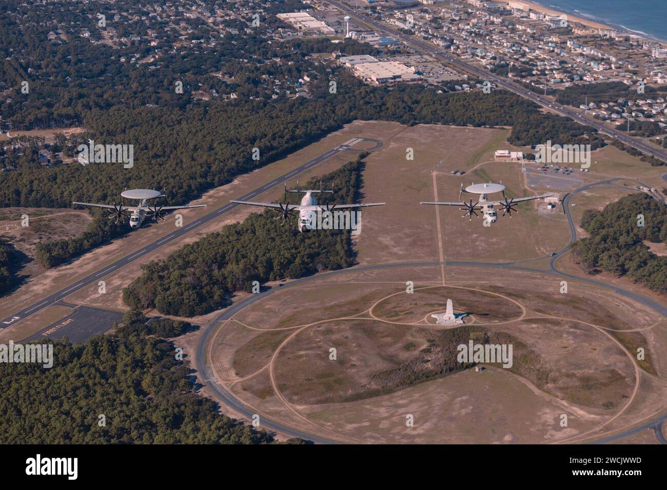 A Grumman C-2A Greyhound an two E-2C Hawkeye of VAW-120 fly over the ...