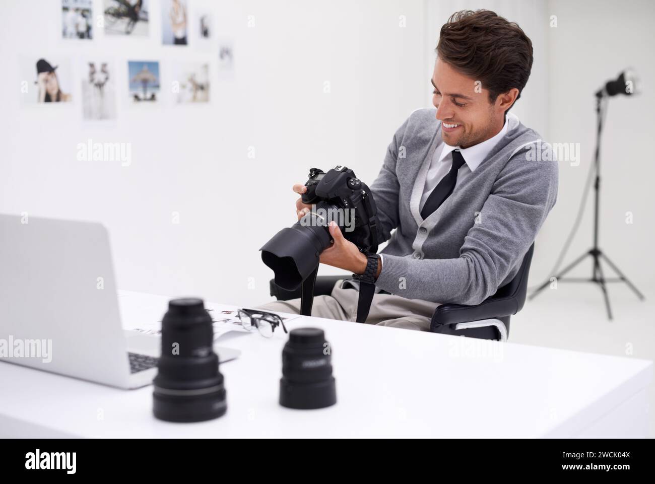 Man, camera and photography in office with happy smile, checking image ...