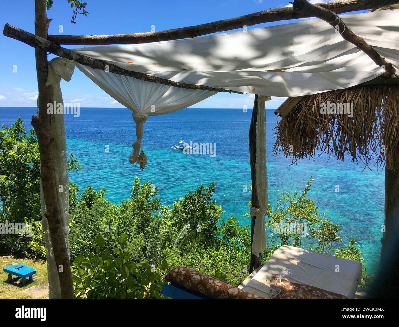 View from a shady launch on a Philippine bay with typical boats with ...
