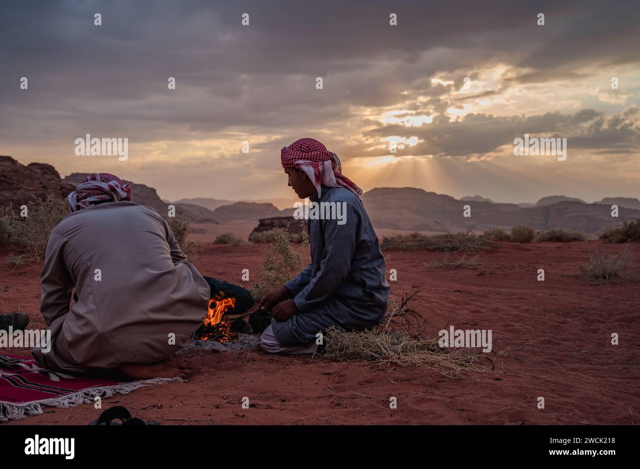 Two bedouins making campfire in the desert Stock Photo - Alamy