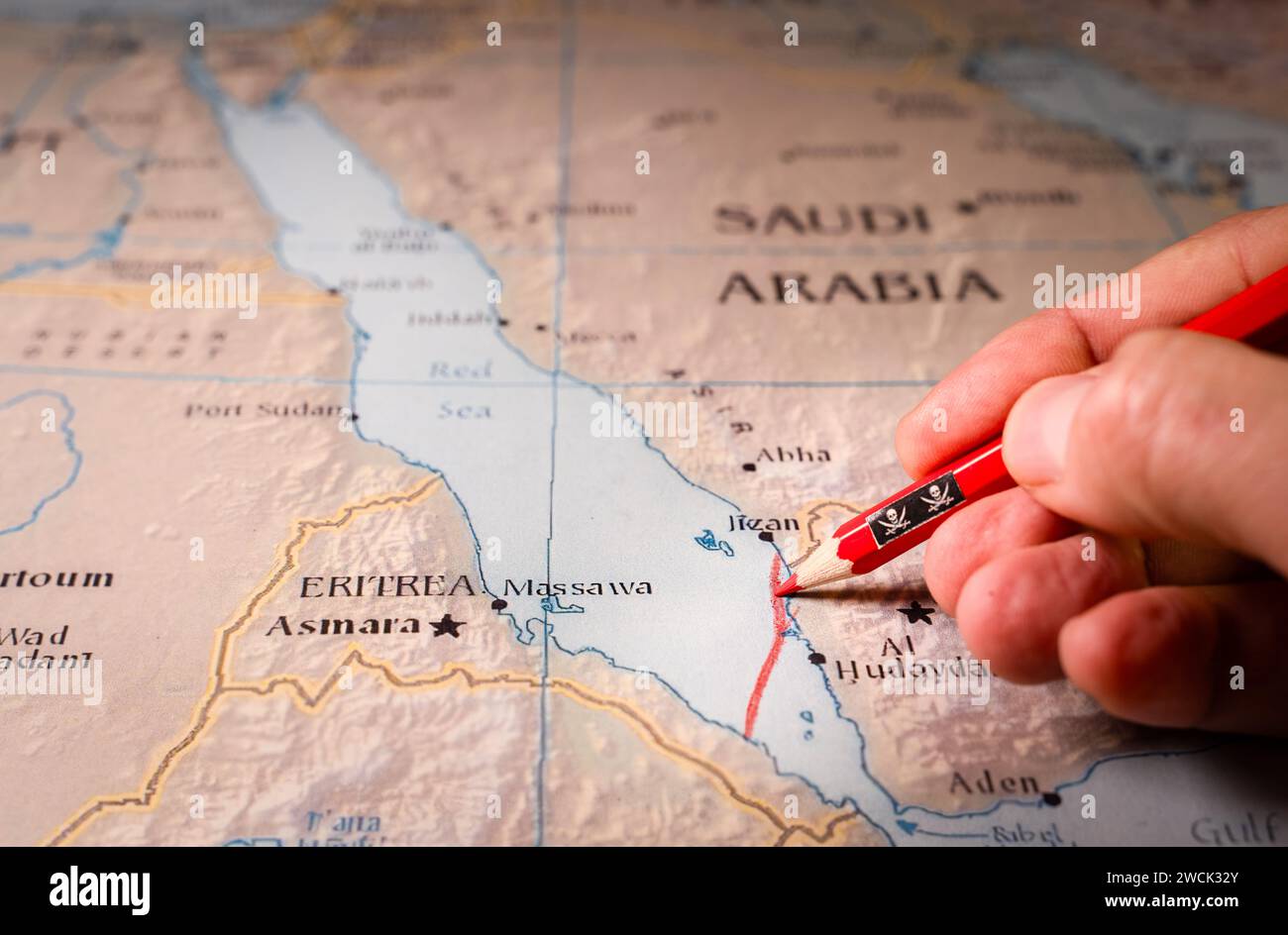 Hand drawing a red line and closing the maritime passage through the ...