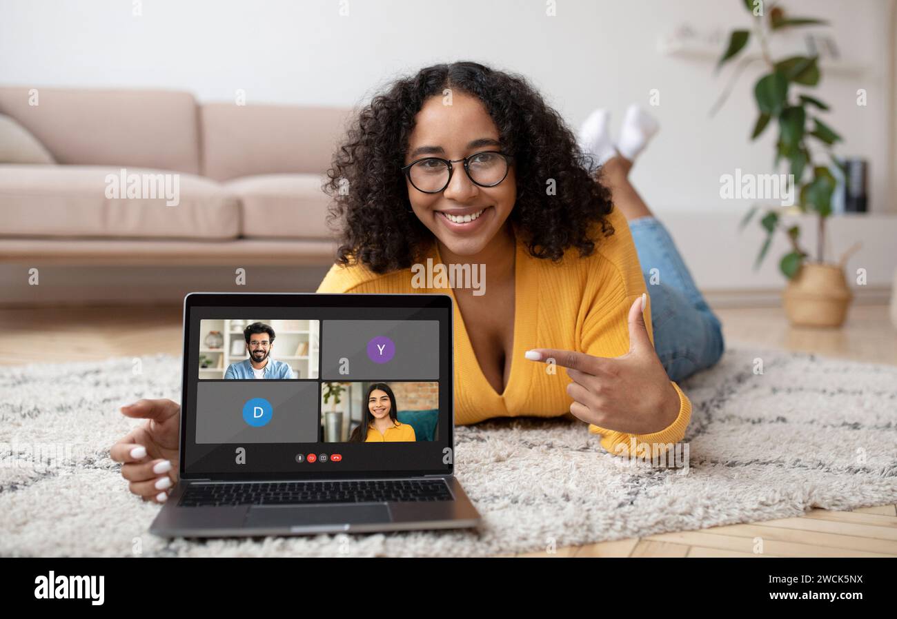 Cheerful black woman showing laptop with video call screen Stock Photo ...