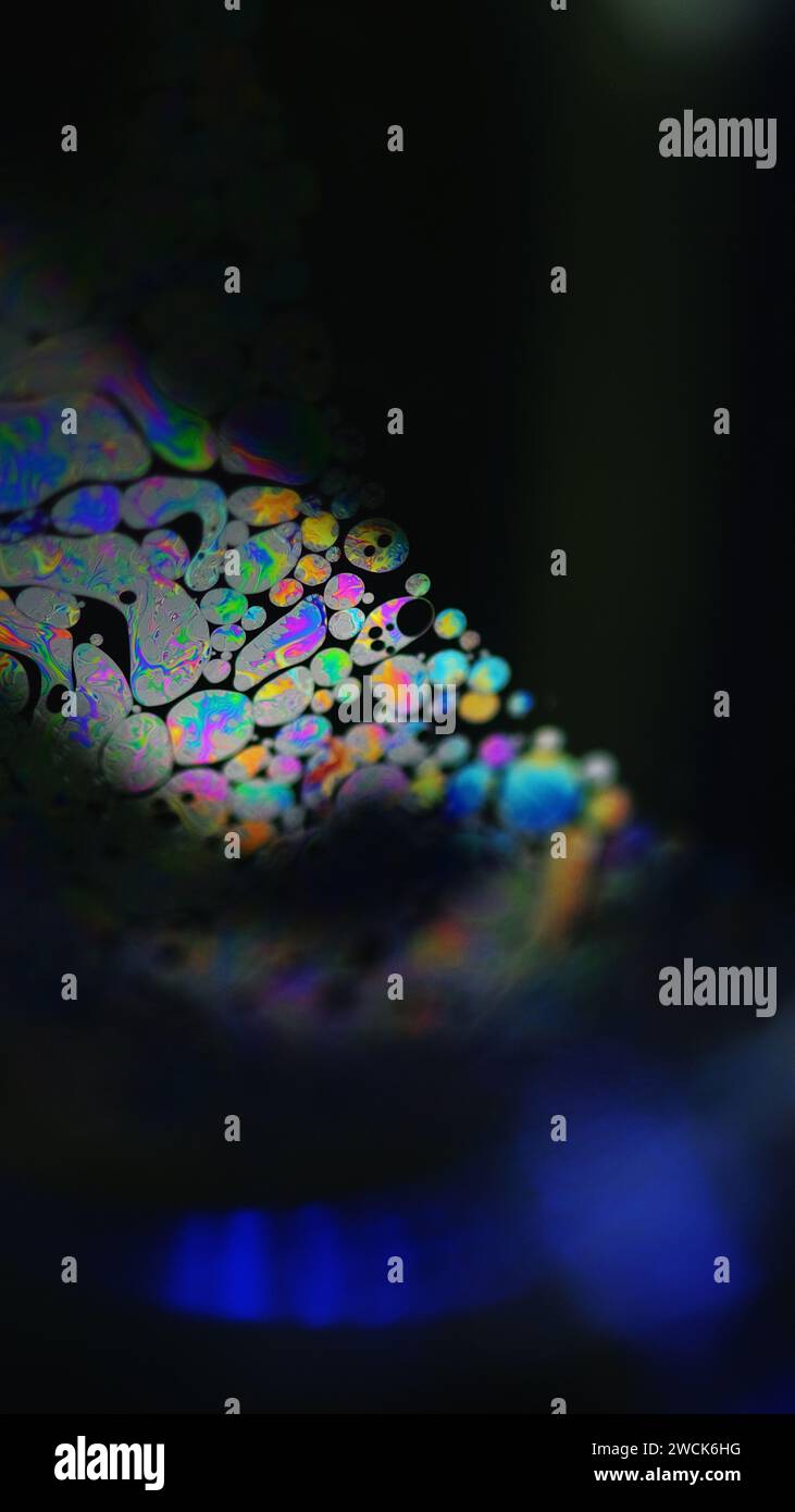 Neon ink holographic fluid color oil paint blend Stock Photo - Alamy