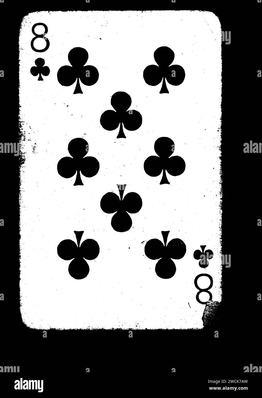 A vintage eight of clubs playing card isolated on a black background ...