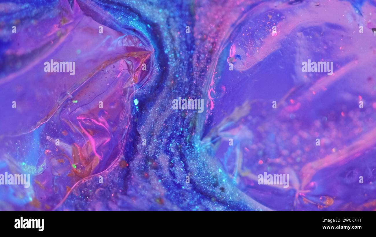 Glitter fluid spill neon cell texture purple blue Stock Photo - Alamy