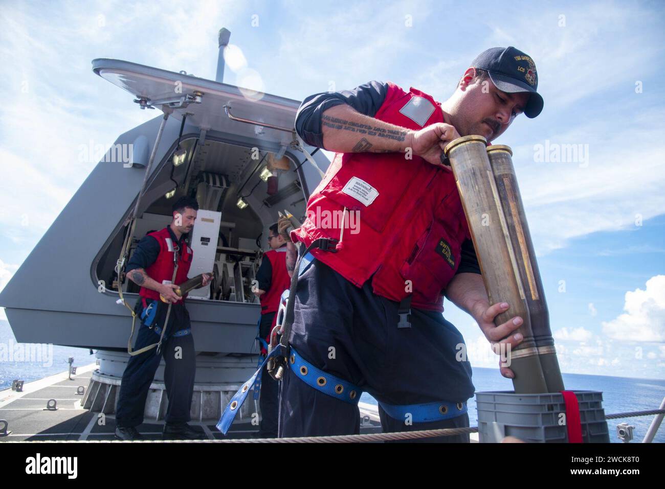 A Sailor handles 57 mm rounds aboard USS Gabrielle Giffords (LCS 10 ...
