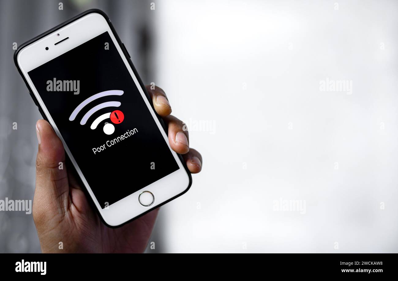 male hand holding a smart phone with sign bad connection on screen ...