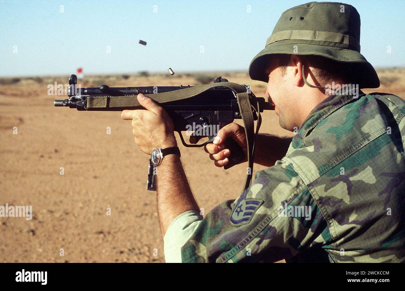 A U.S. Air Force SSGT fires a 9-mm HK MP5 sub-machine gun at a firearms ...