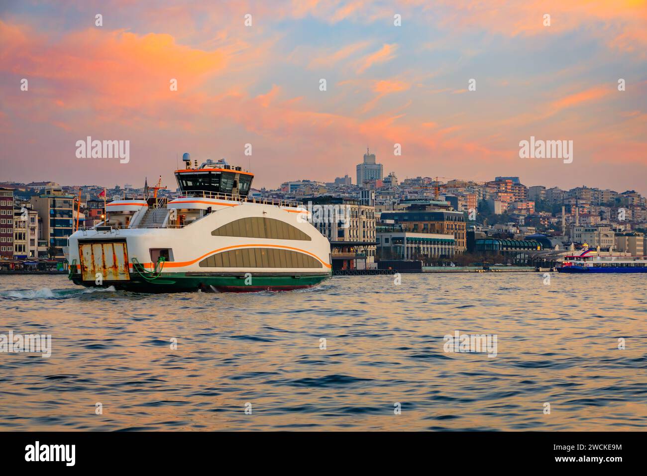 A ferry and a sunrise cityscape of the Karakoy area in Galata Port ...